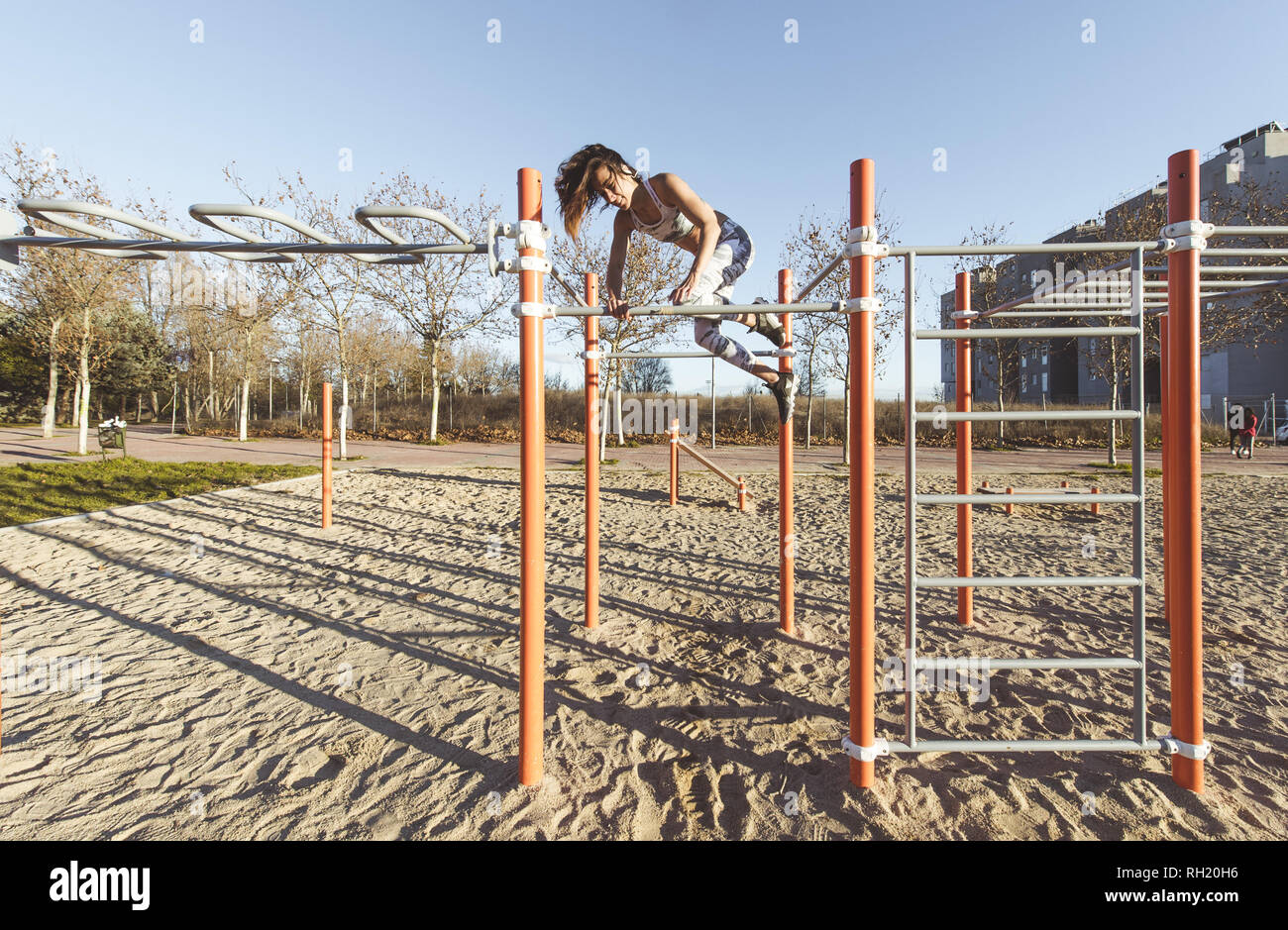 Woman training on parallel bars on street Stock Photo - Alamy
