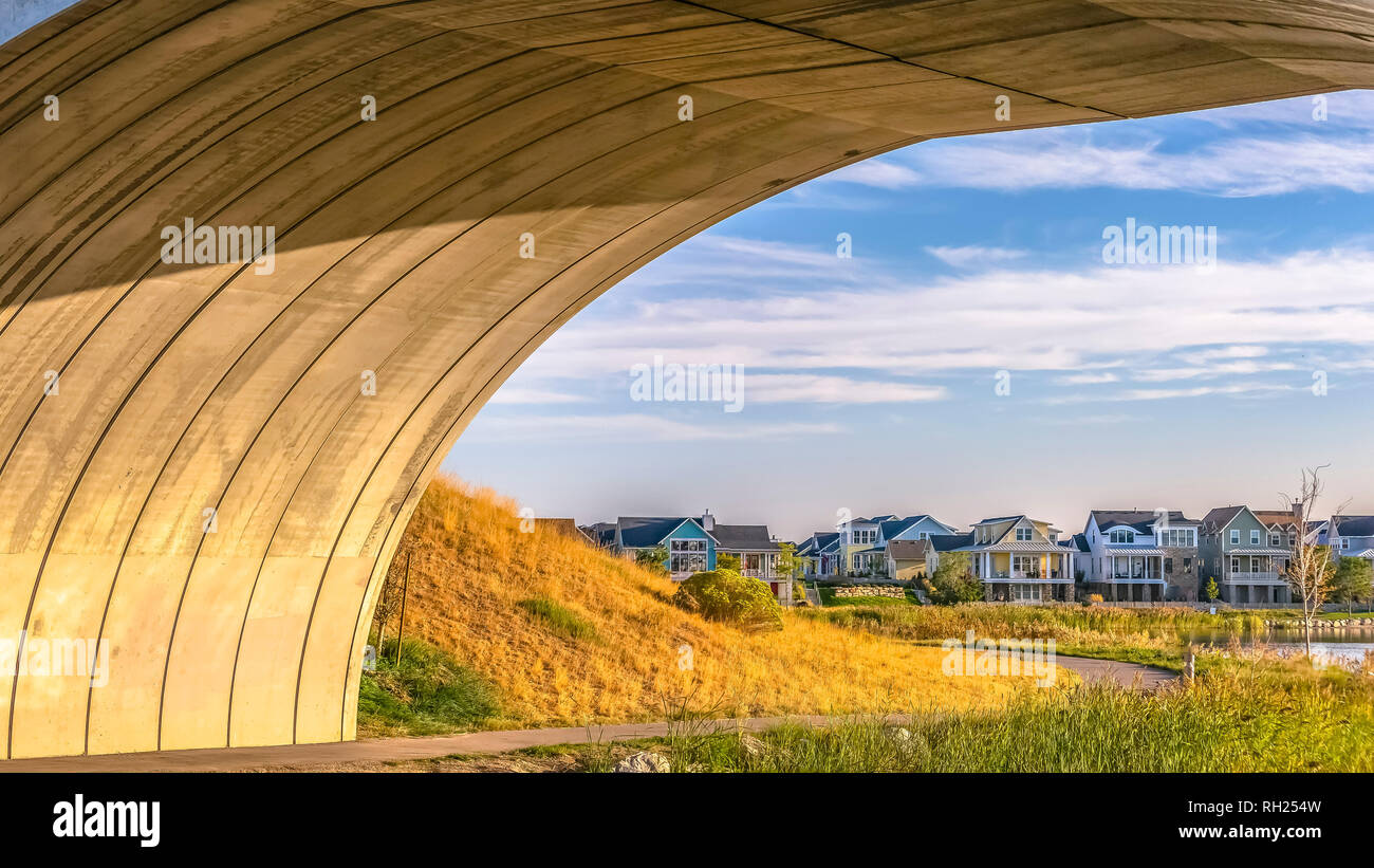 Pathway under an arched bridge in Oquirrh Lake Stock Photo - Alamy