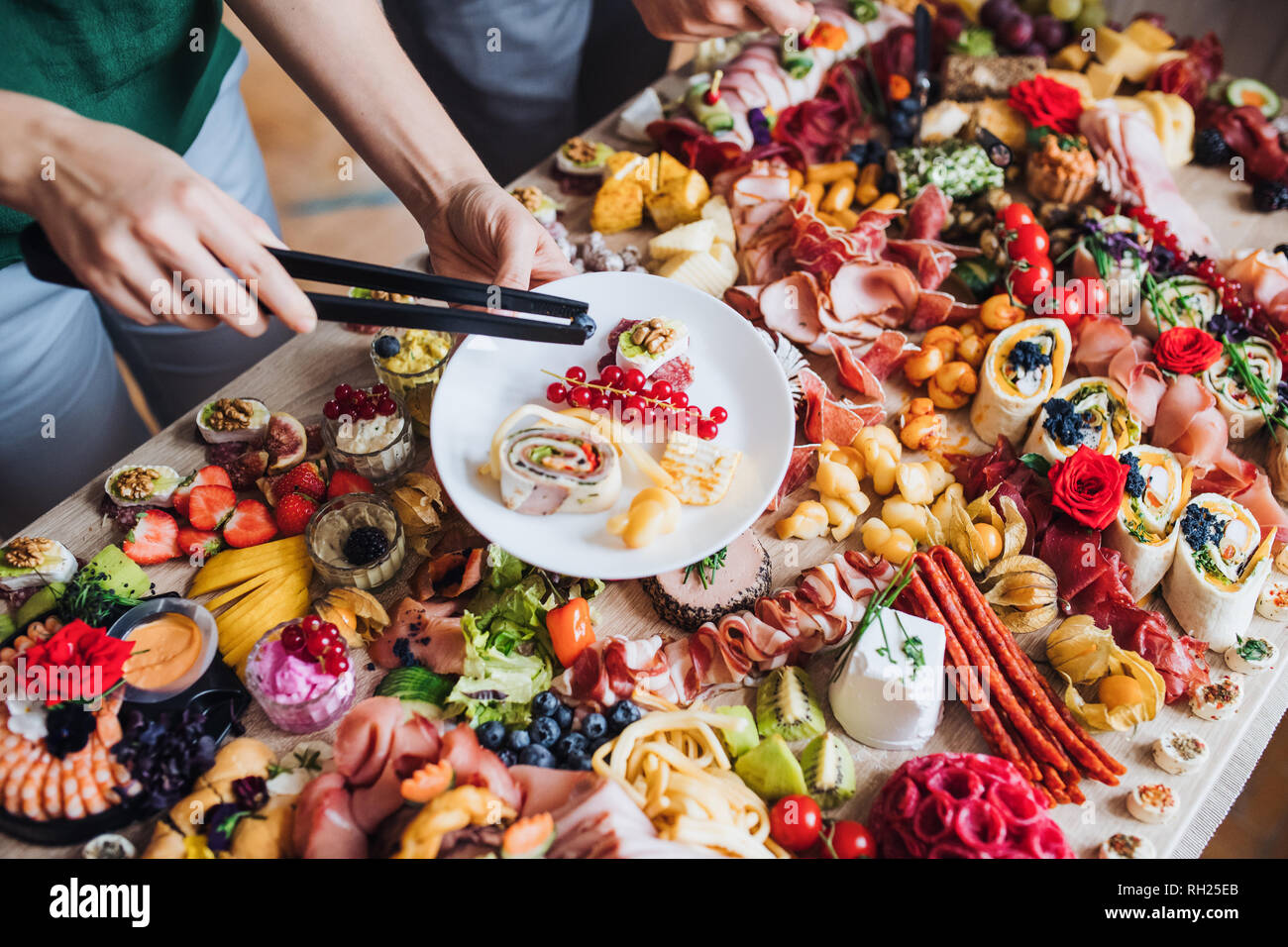 Buffet table woman putting food hi-res stock photography and images - Alamy