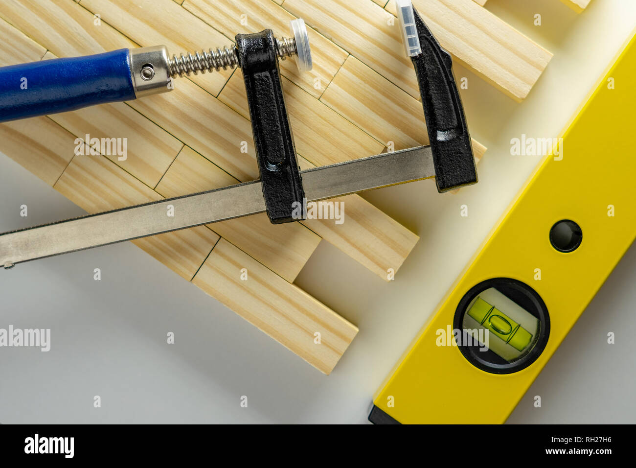 Building tools: waterpas and clamp with wooden blocks background Stock ...