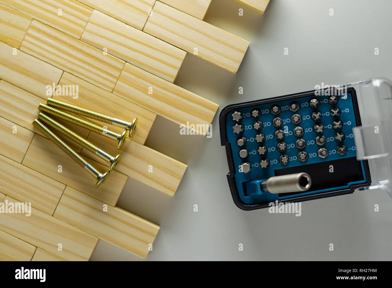 Building tools: furniture bolts and screwdriver bit set with wooden ...
