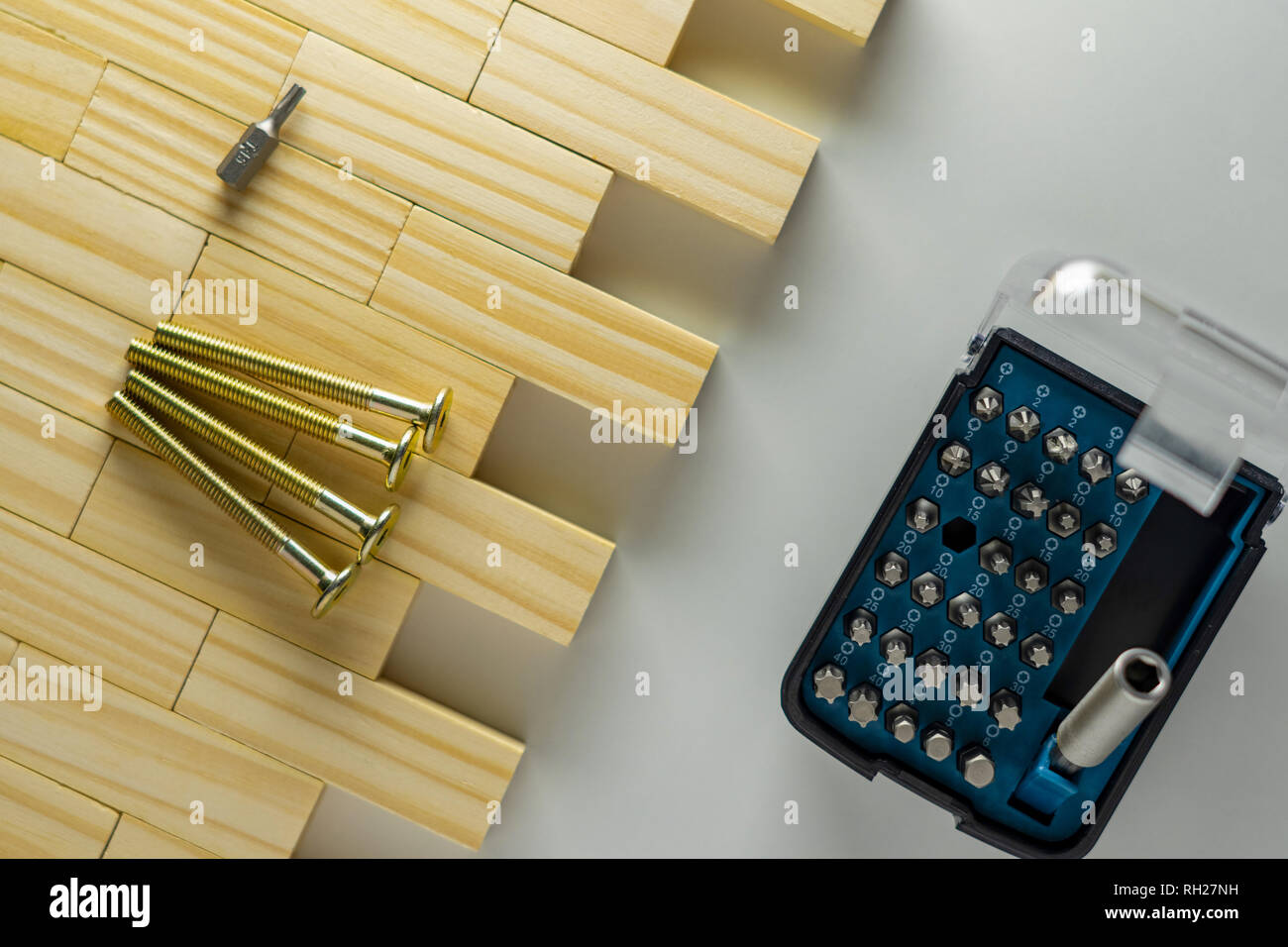 Building tools: furniture bolts and screwdriver bit set with wooden ...
