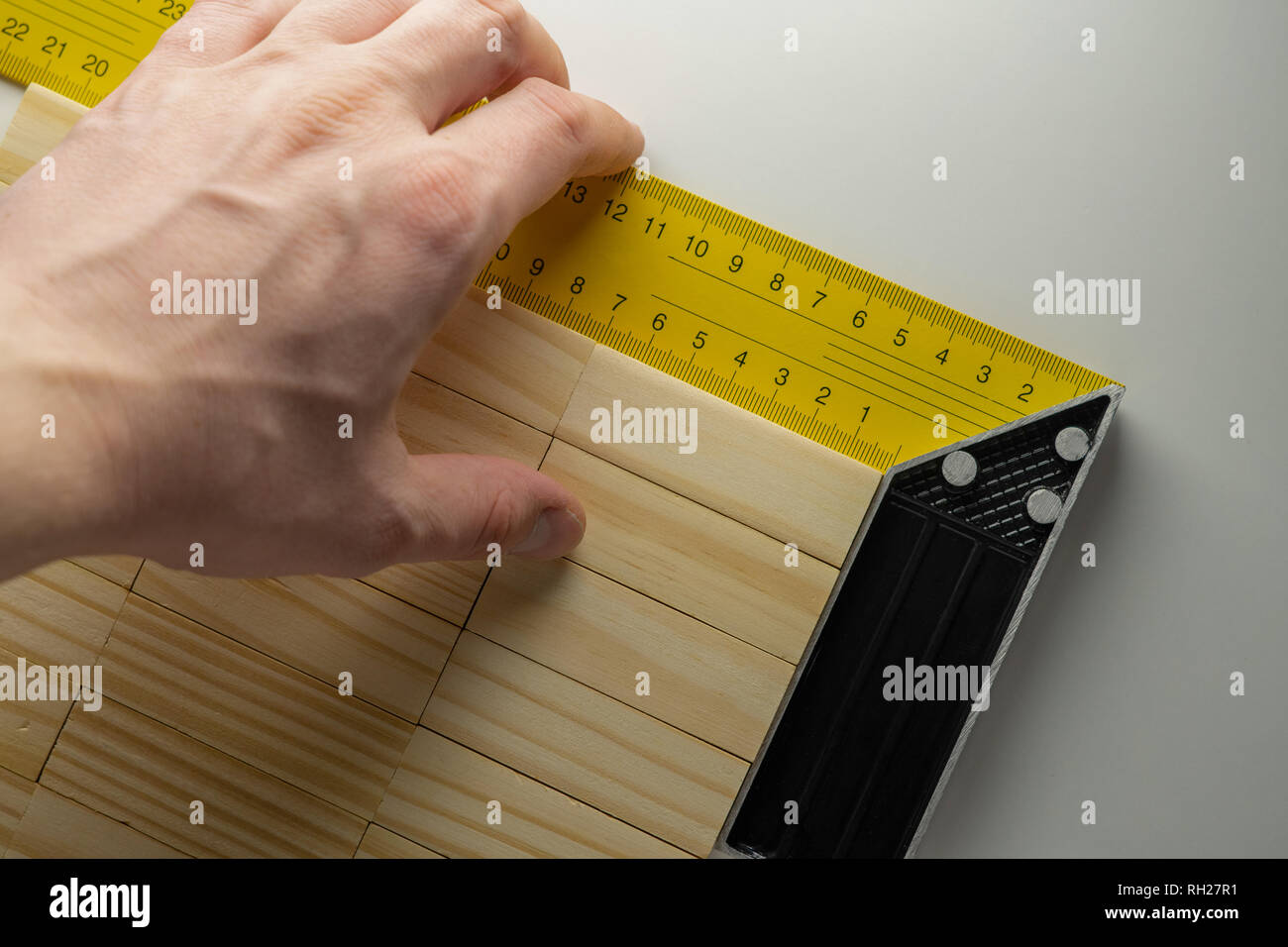 Checking the corner of the table, hand with corner ruler and wooden ...