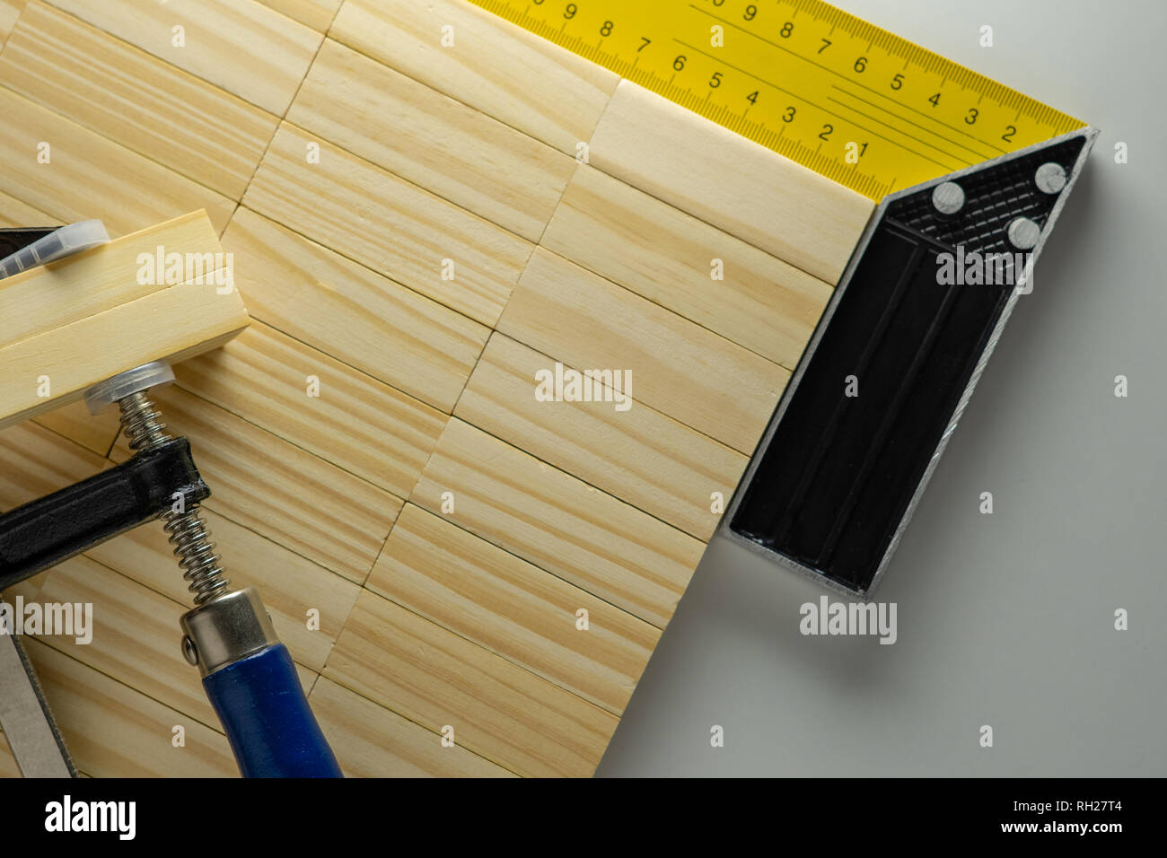 Building tools: corner ruler and clamp with wooden blocks background ...