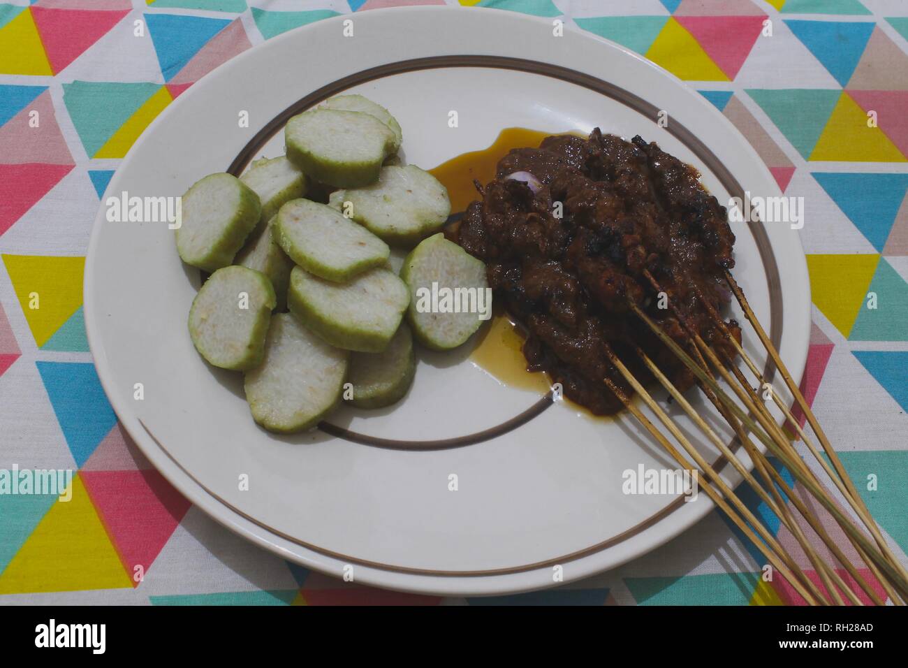 one of Indonesia traditional food, chicken satay with rice cake ...