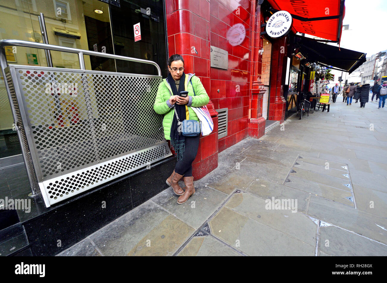 London, England, UK. Woman on her mobile phone outside Covent Garden ...