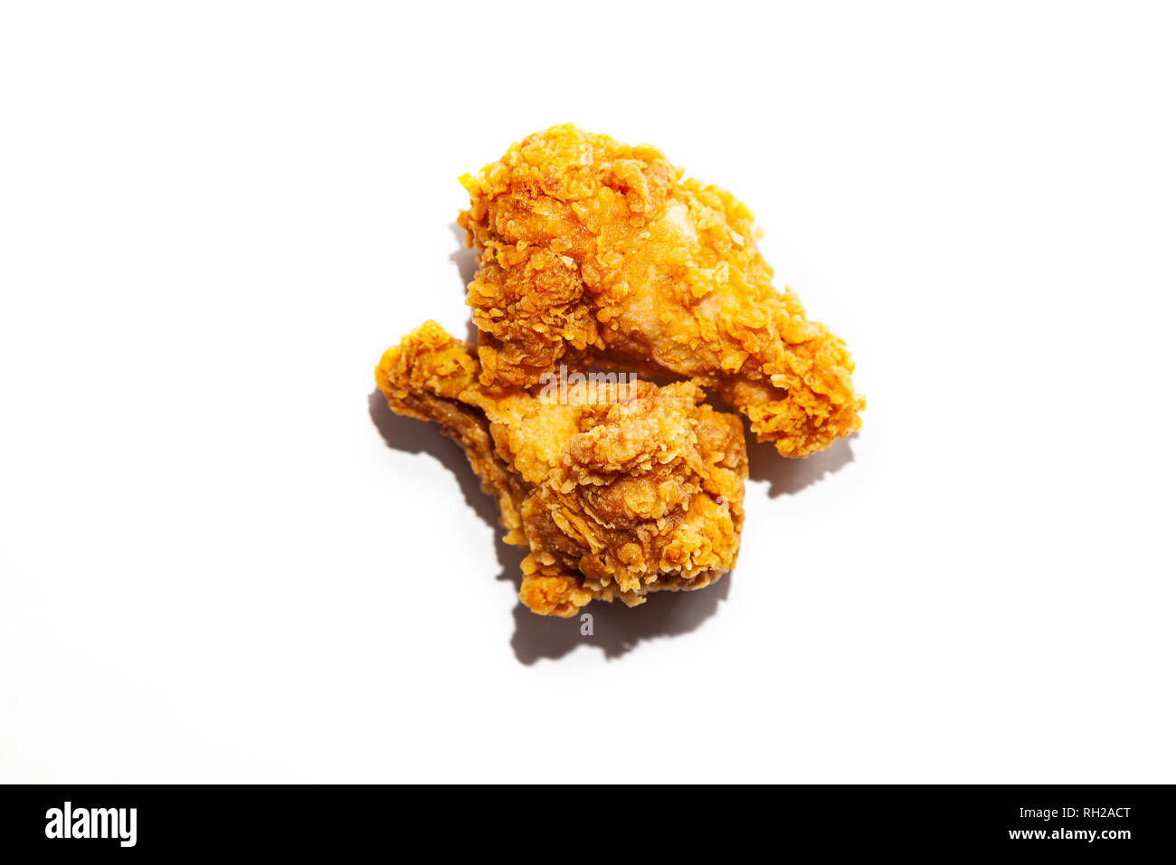 Fried chicken wings in spicy sauce and breaded brown color lie side by ...