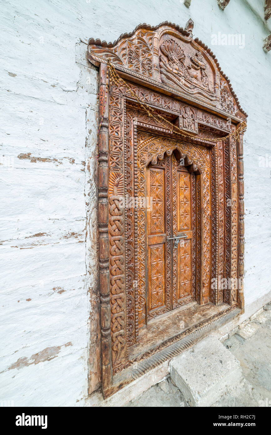 Traditional Illustration on wooden door of temple in sainj valley ...