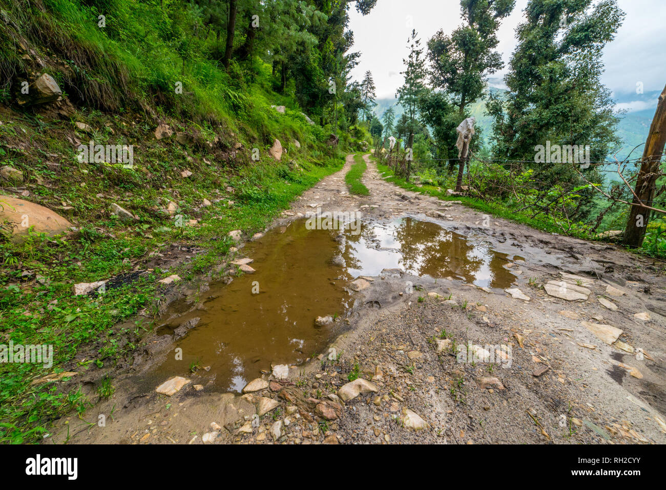 Photo of Muddy road leading into the distant rural landscape with ...
