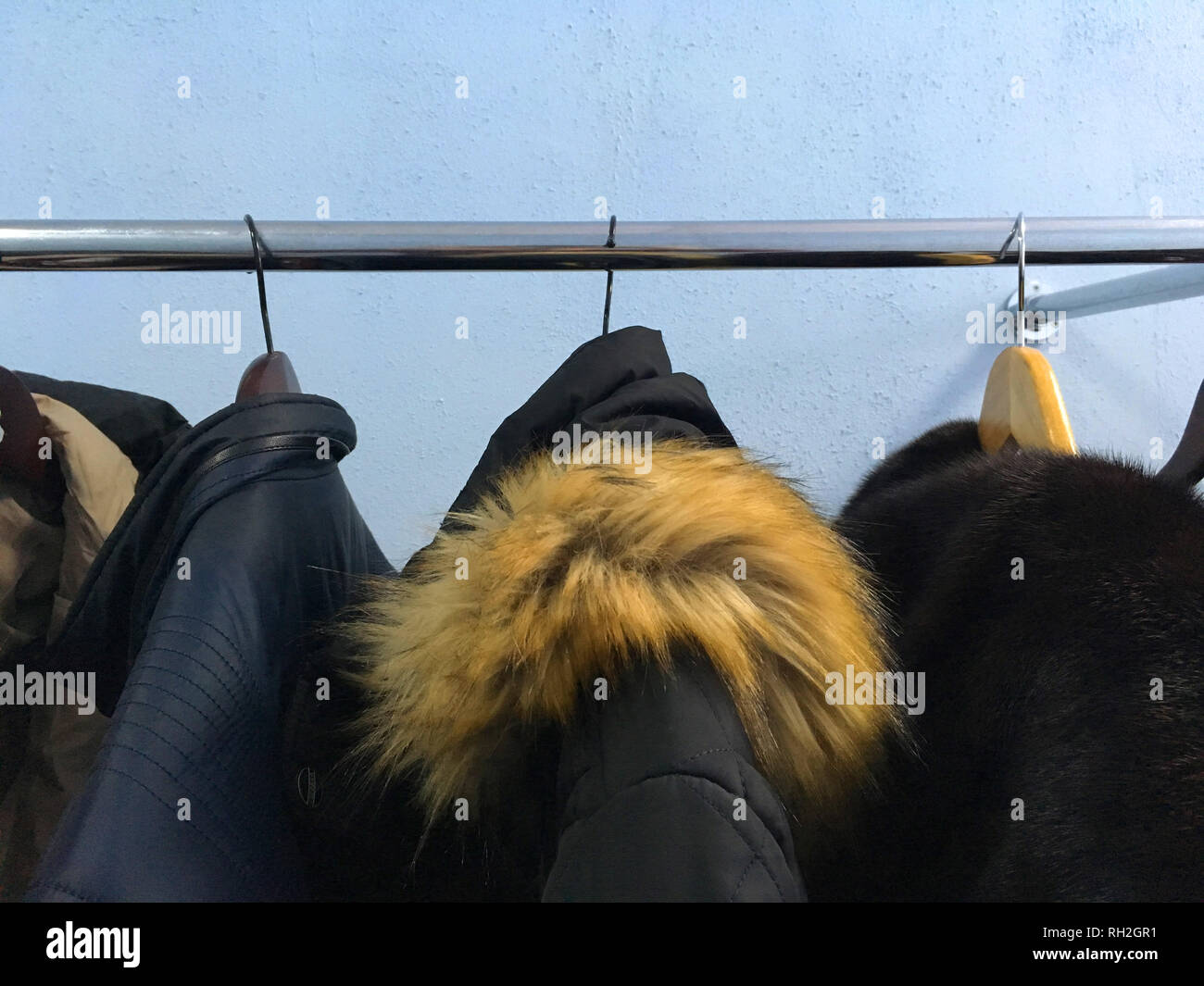 Coats hanging on a rack hi-res stock photography and images - Alamy