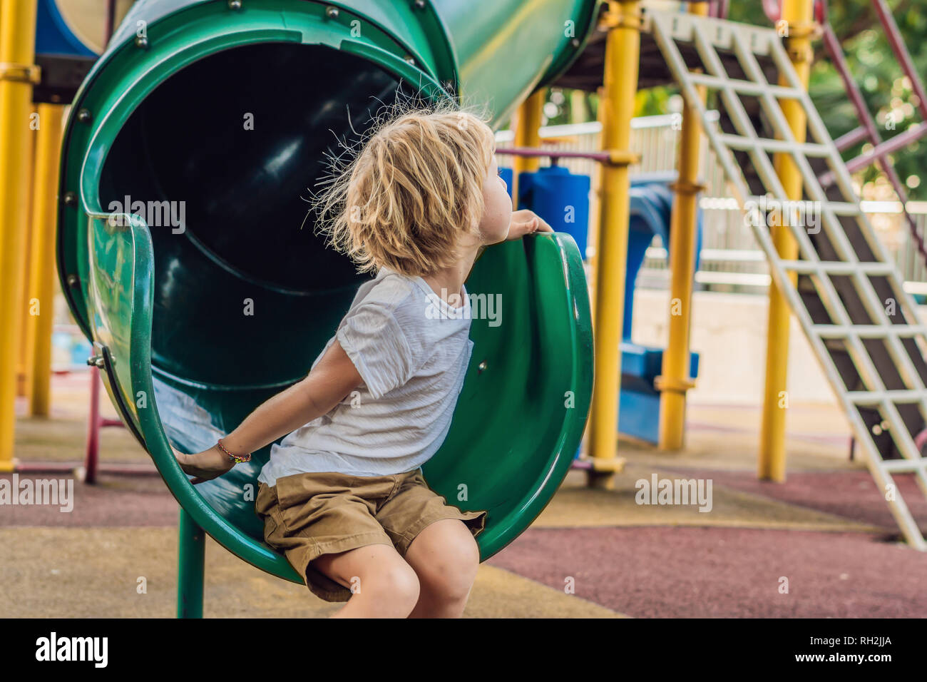 Funny cute happy baby playing on the playground. The emotion of ...