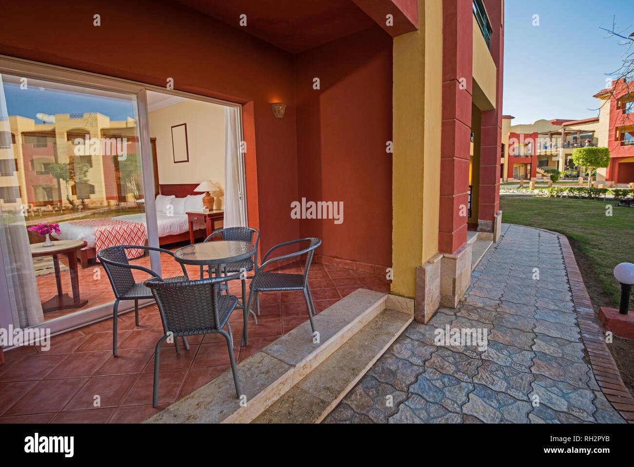View from a balcony terrace of luxury hotel resort room with gardens ...