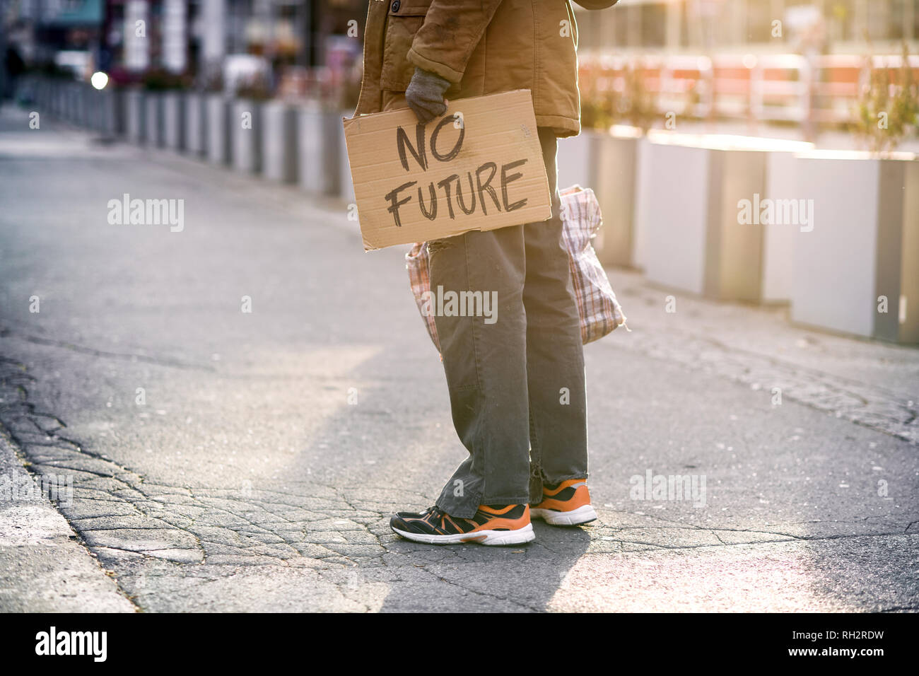 A Midsetion Of Homeless Beggar Man Standing Outdoors On A Road Holding