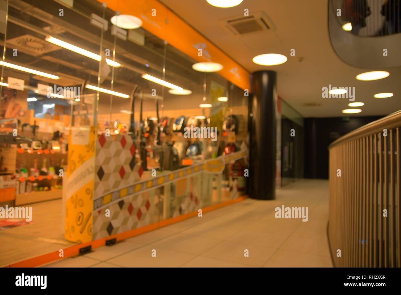 Blurred view of electronic shop. Corridor in shopping malll and view of ...