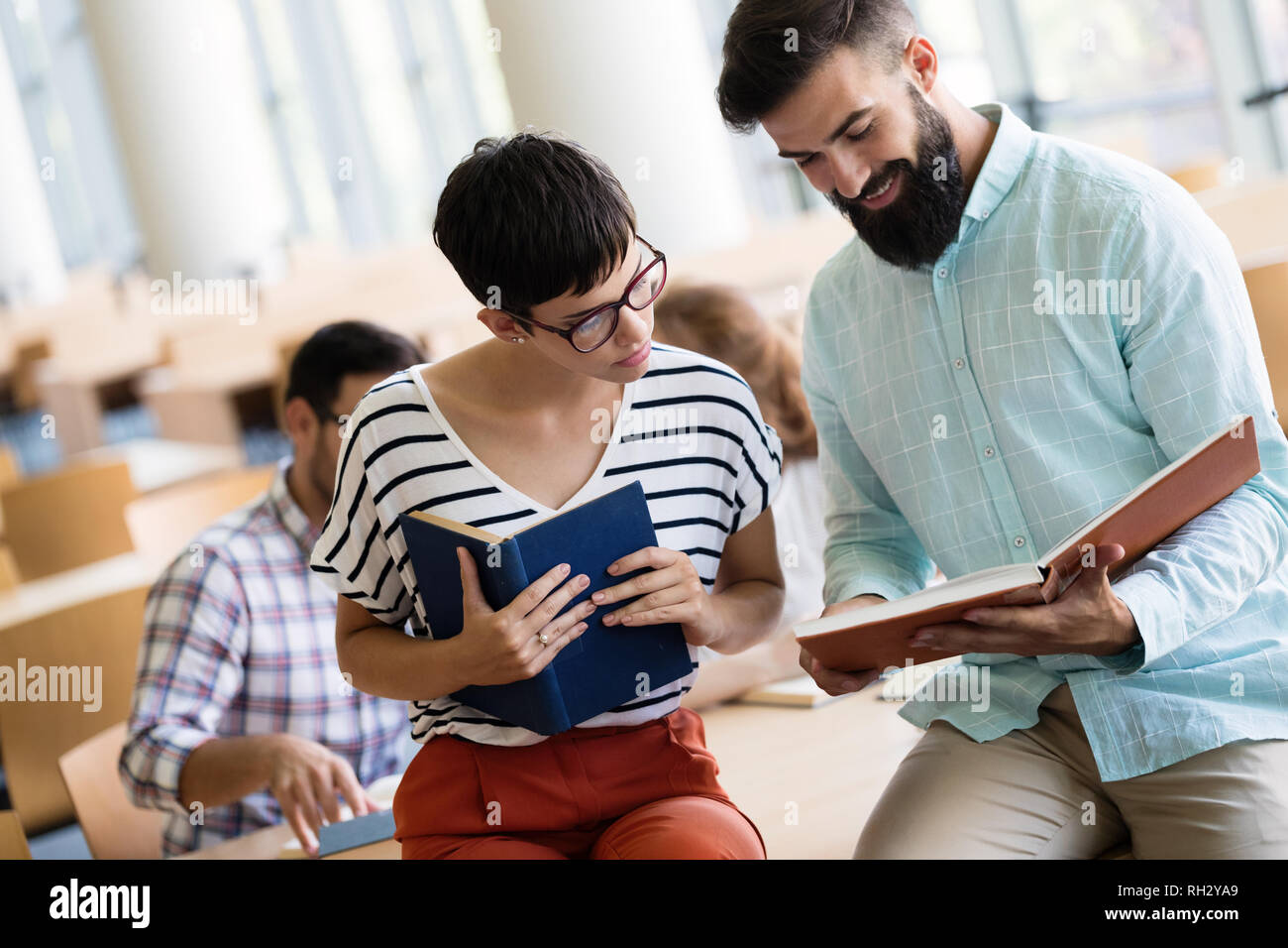 Happy students couple in school library have discussion Stock Photo - Alamy