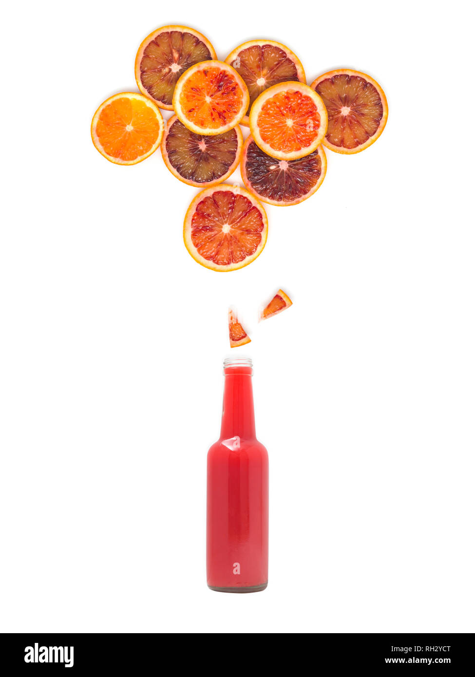 bottle with fresh blood orange juice is standing under many blood ...