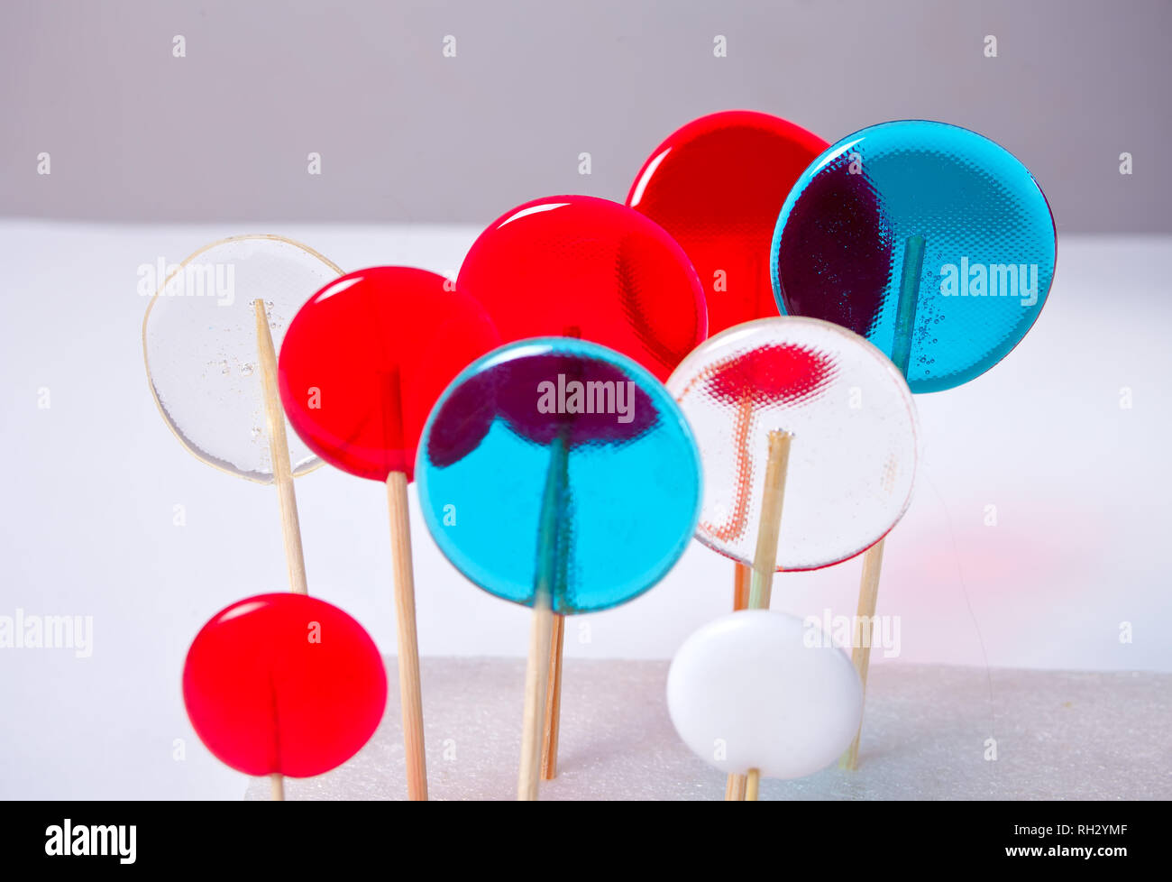 colorful red, blue, white lollipops on the white background Stock Photo ...