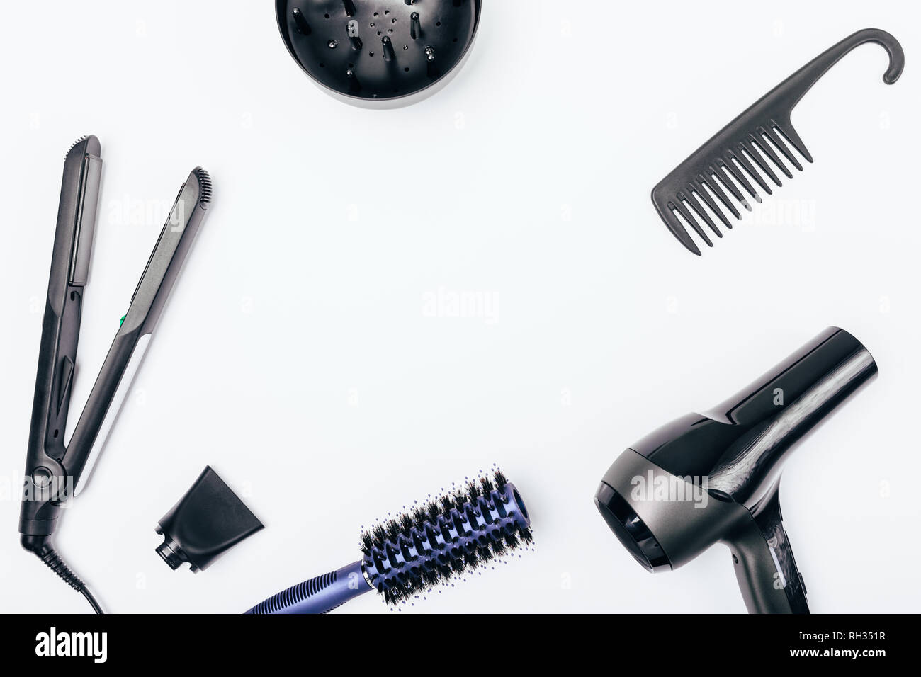 Devices and tools for hair styling on white background with blank space ...