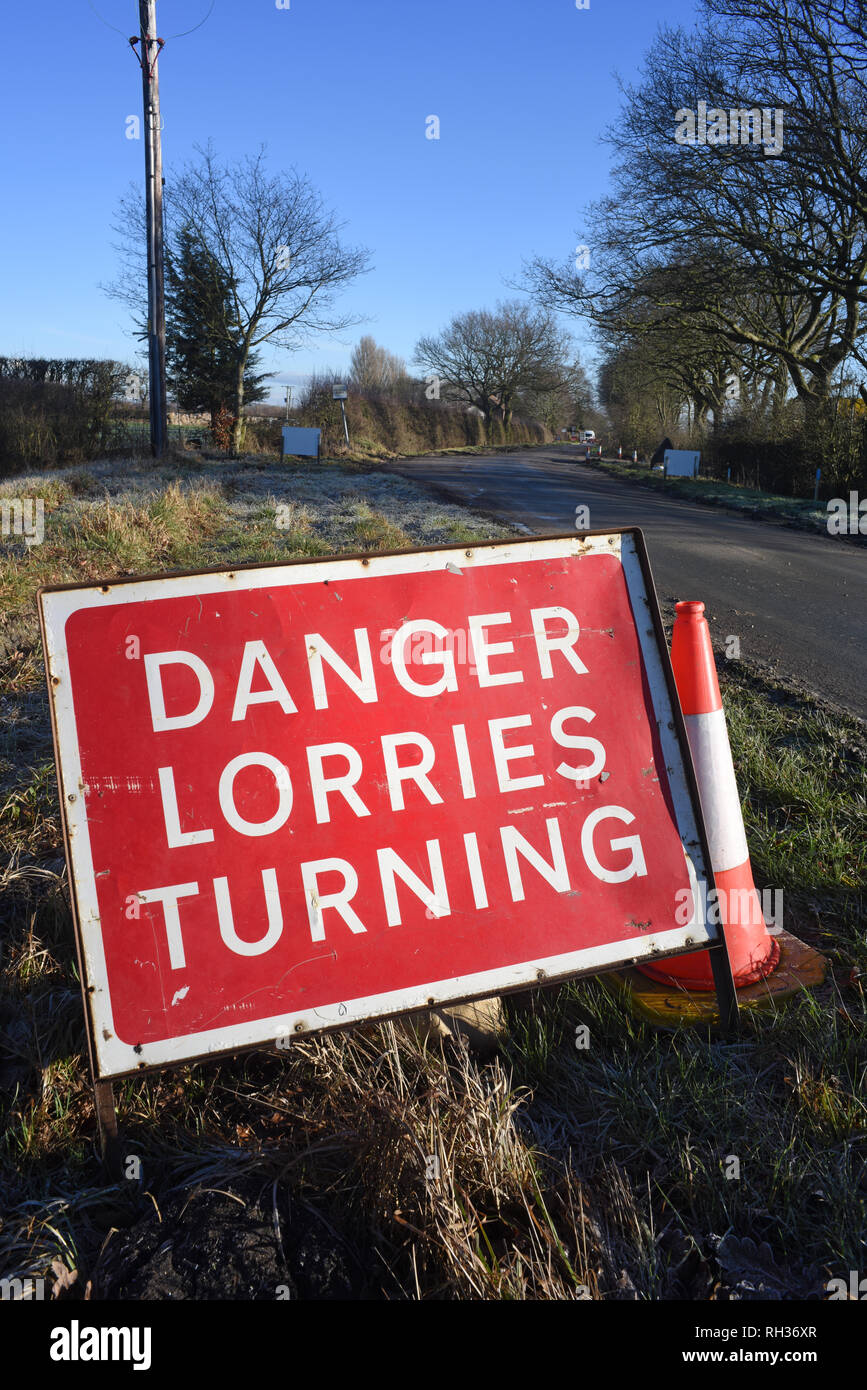 danger lorries turning in road ahead warning sign at construction site ...