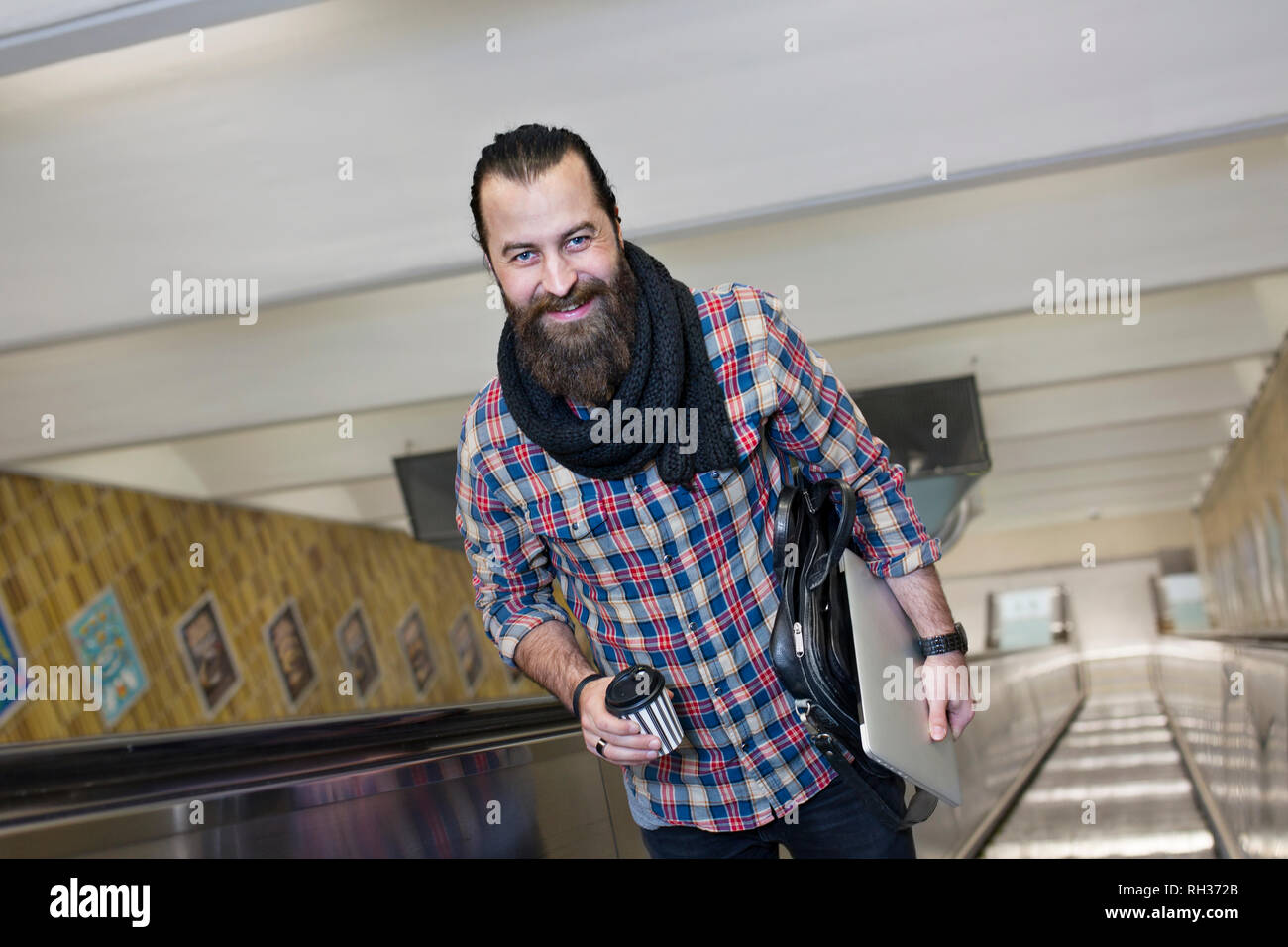 Portrait of mature man on escalator Stock Photo - Alamy