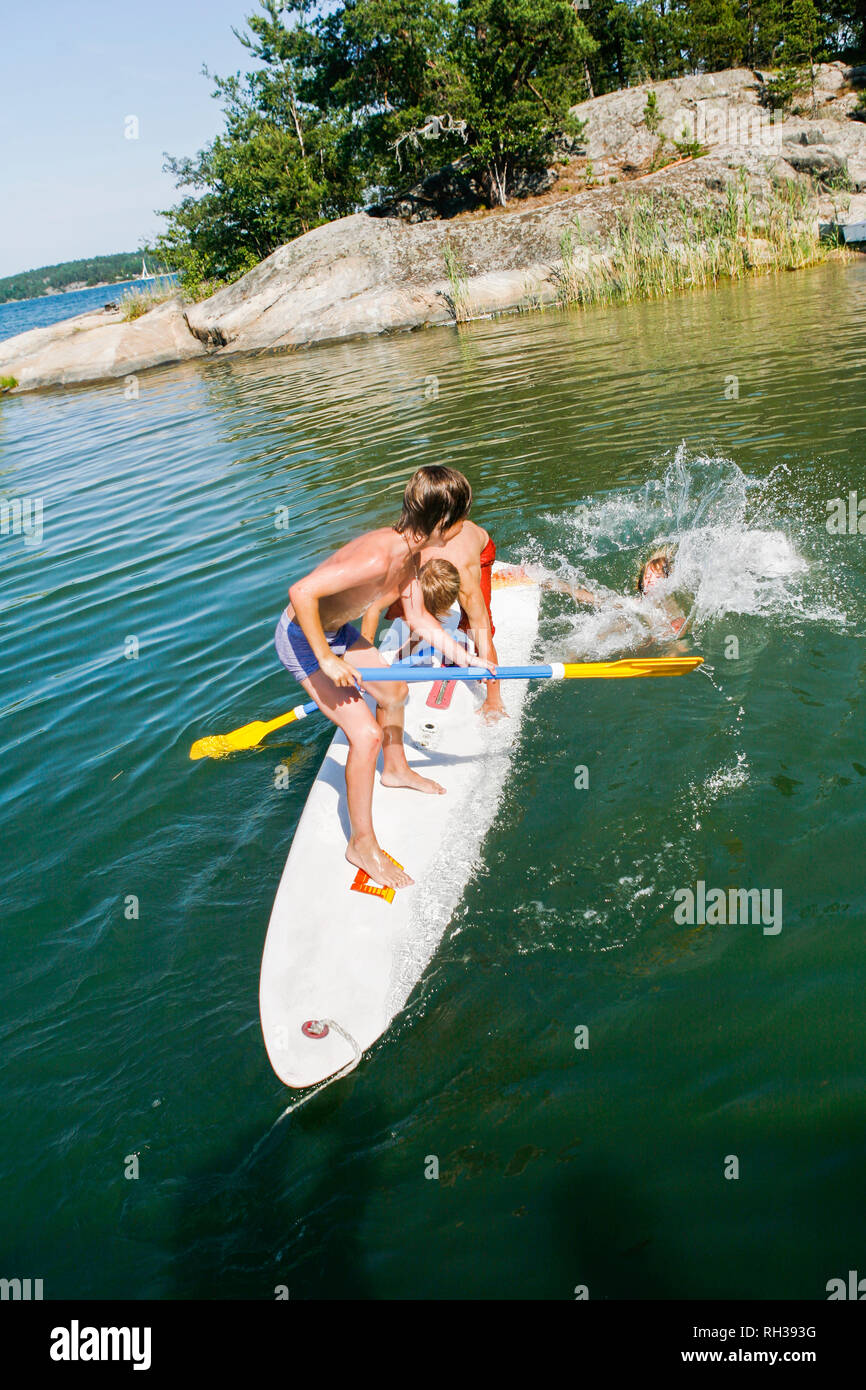 Children paddle board hi-res stock photography and images - Alamy