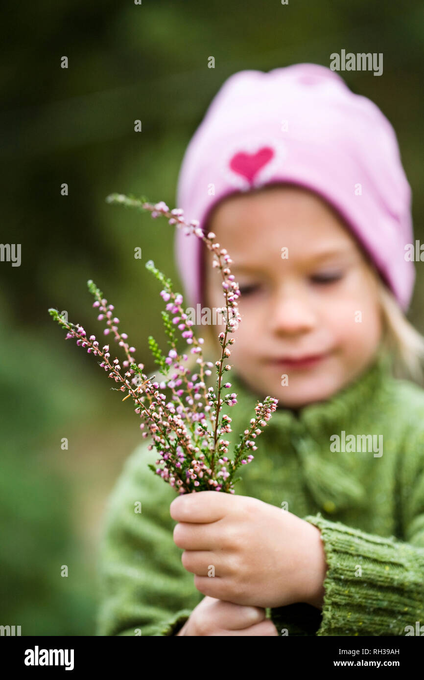 Girl holding heather Stock Photo - Alamy