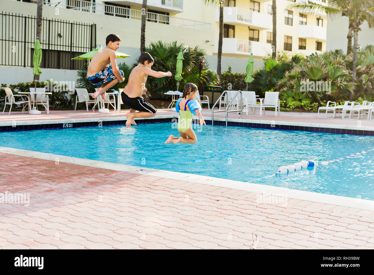 Children jumping into pool Stock Photo - Alamy