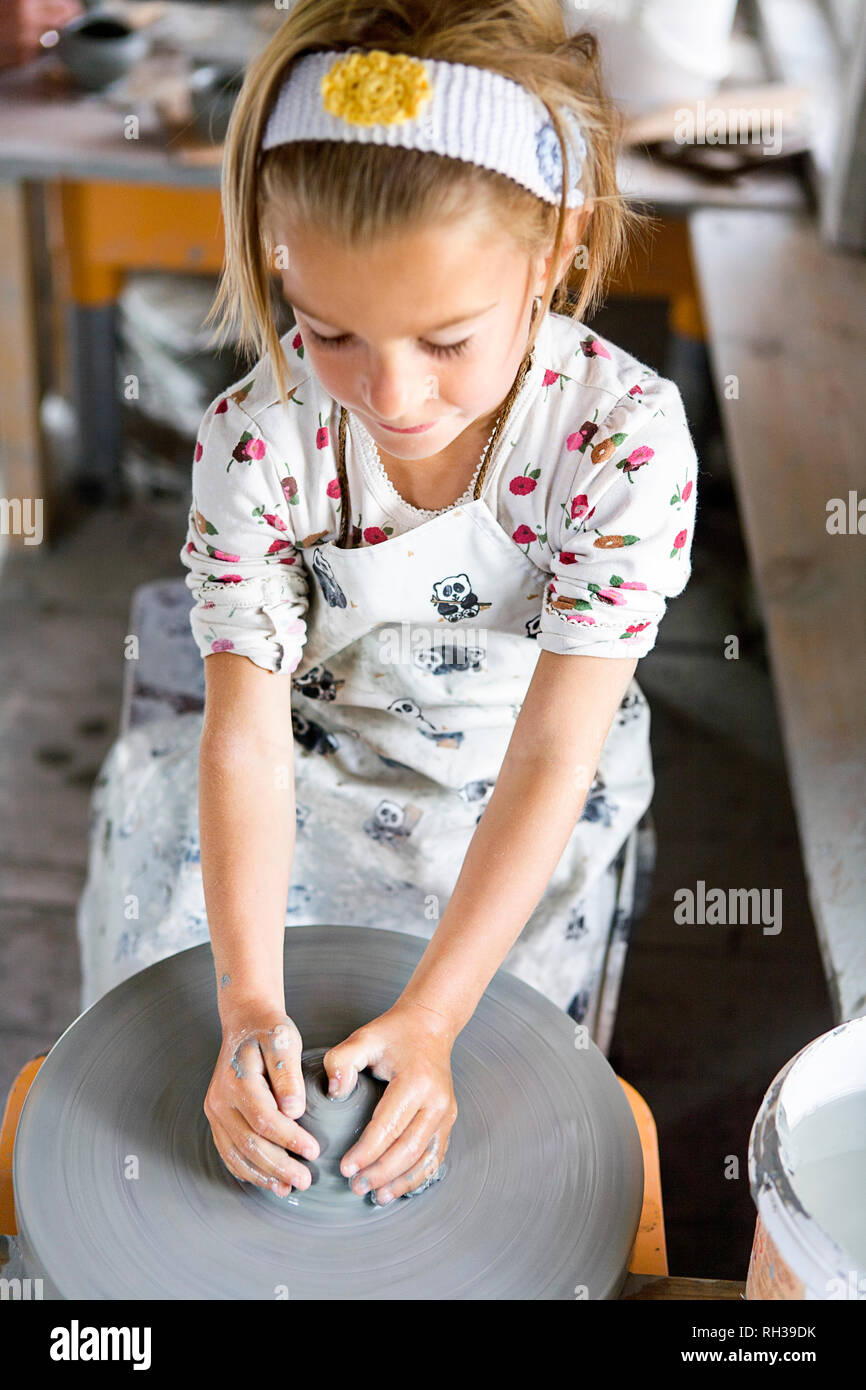 Girl forming pottery on wheel Stock Photo - Alamy