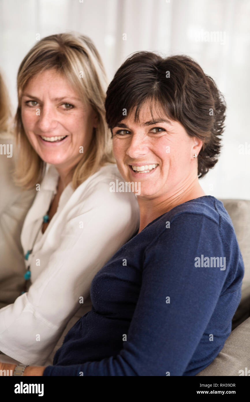Mature women friends laughing indoors hi-res stock photography and ...