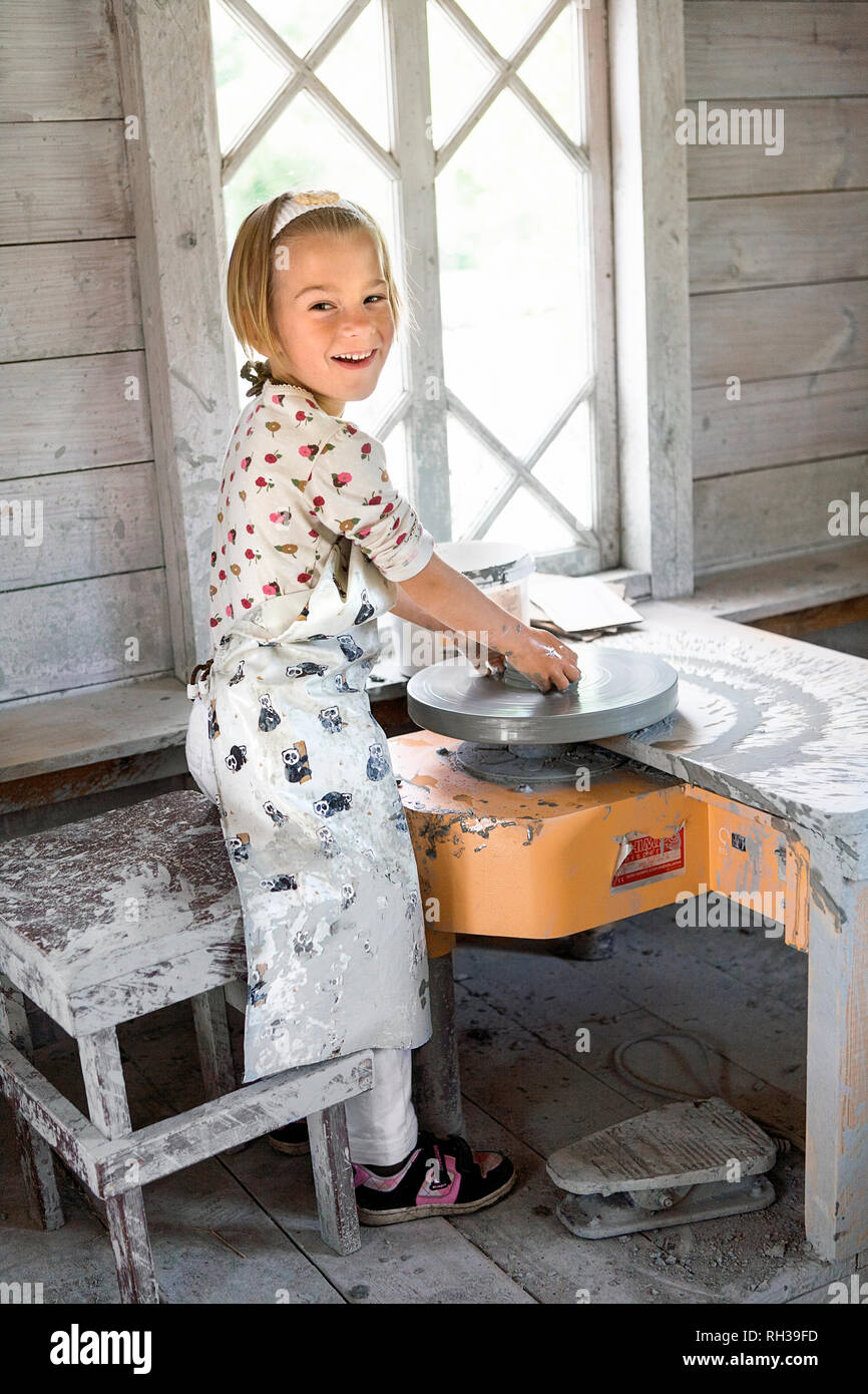 Girl forming pottery on wheel Stock Photo - Alamy