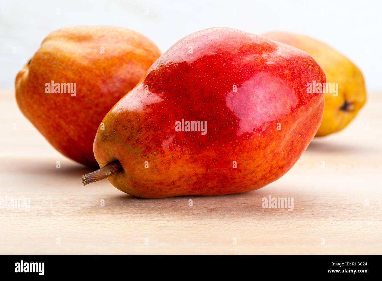Delicious red pears. On light wood background Stock Photo - Alamy