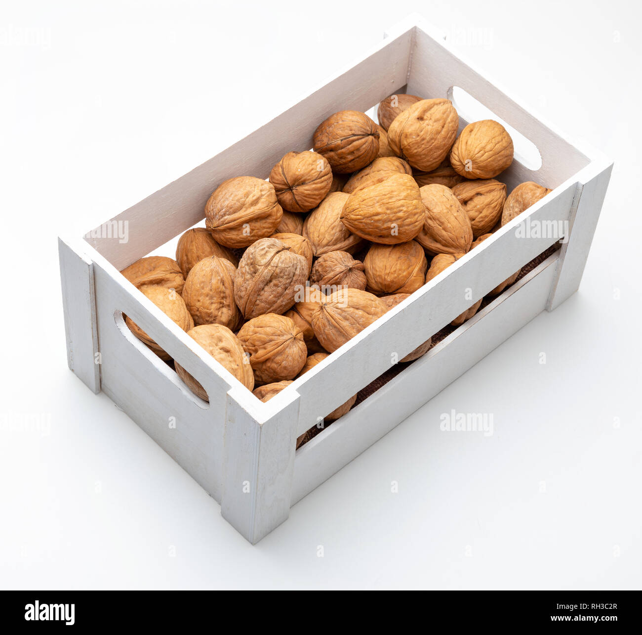 Walnuts in wooden box. Rustic appearance. Isolated on white background ...