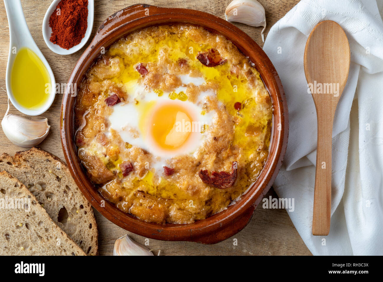 Garlic and bread soup (Castilian, from Spain) in clay pot and its main ...
