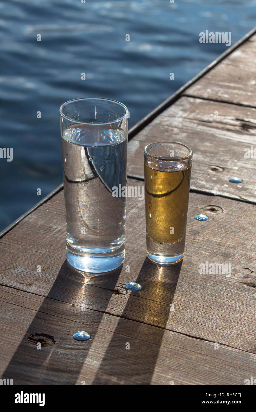 A glass of water and a glass of alcohol on the bridge Stock Photo - Alamy