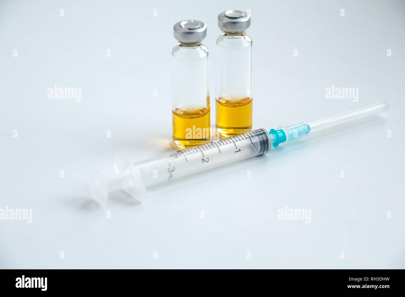 Sterile medical vials with blue medication solution, ampoules, and ...