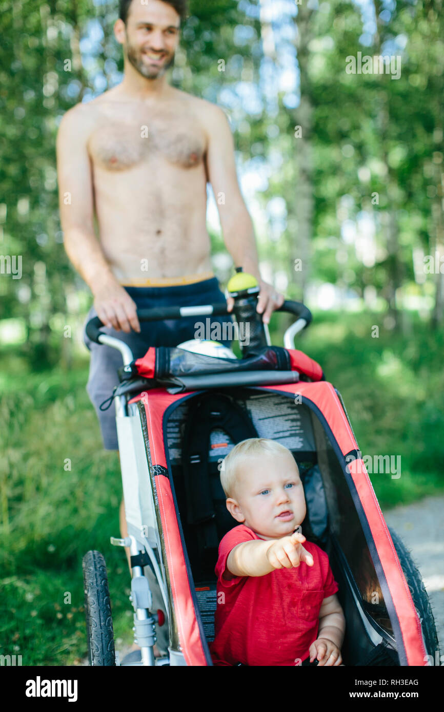 Father with son in jogging pram Stock Photo - Alamy