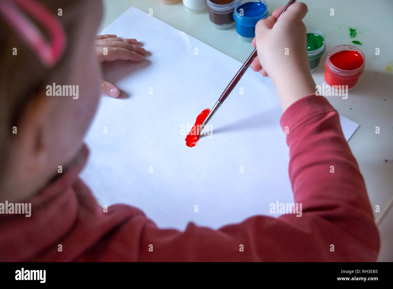 Gouache and water for painting and two kids drawing on background Stock ...