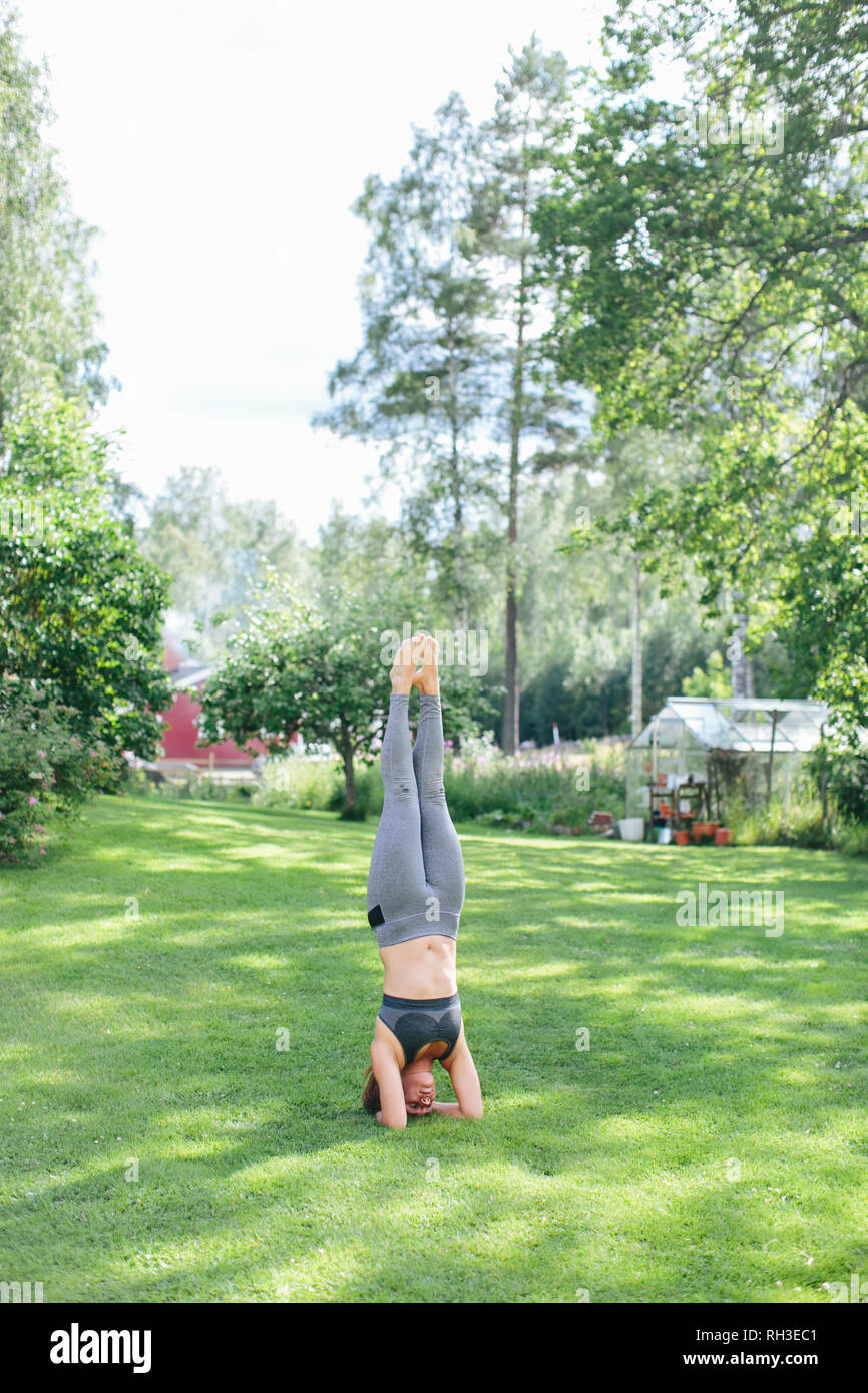 Woman doing headstand hi-res stock photography and images - Alamy