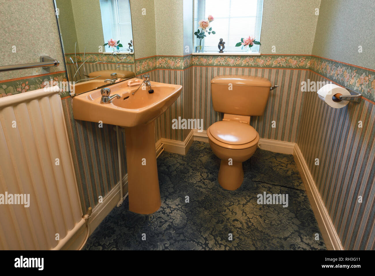 An old fashioned brown coloured suite in a downstairs toilet Stock Photo Alamy