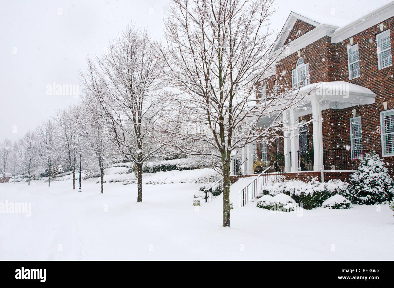 Traditional Brick Home in a Snow Storm Stock Photo - Alamy