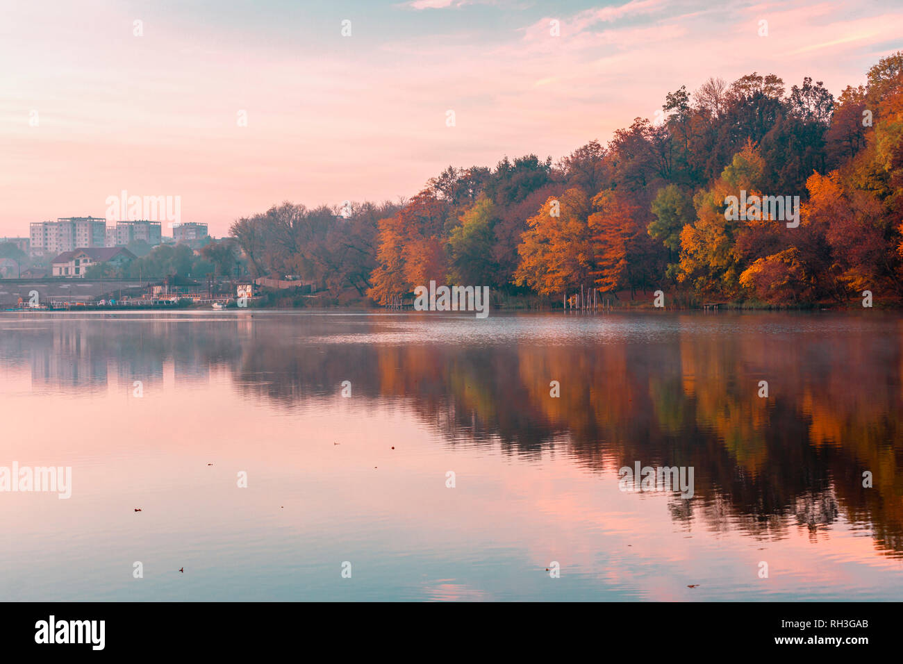 Beautiful october morning sunrise with colorful trees reflected on the ...