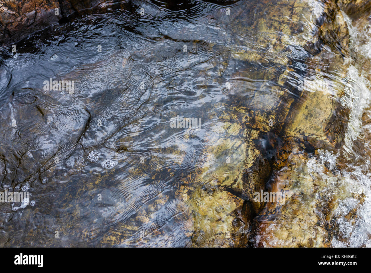 Clear water waves passing stones from Parc des Cascades, in Rawdon ...