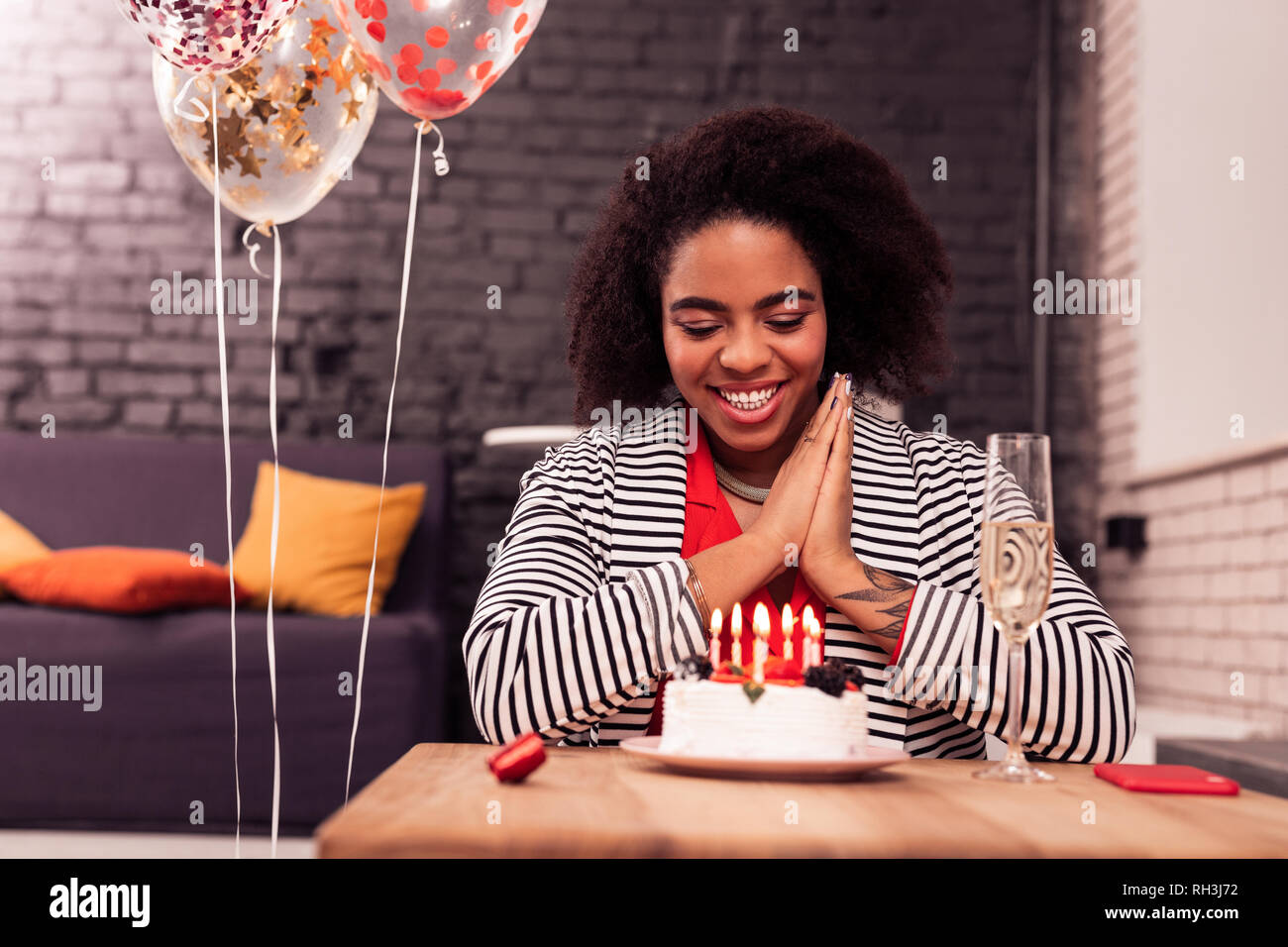 Nice excited woman putting her hands together Stock Photo - Alamy