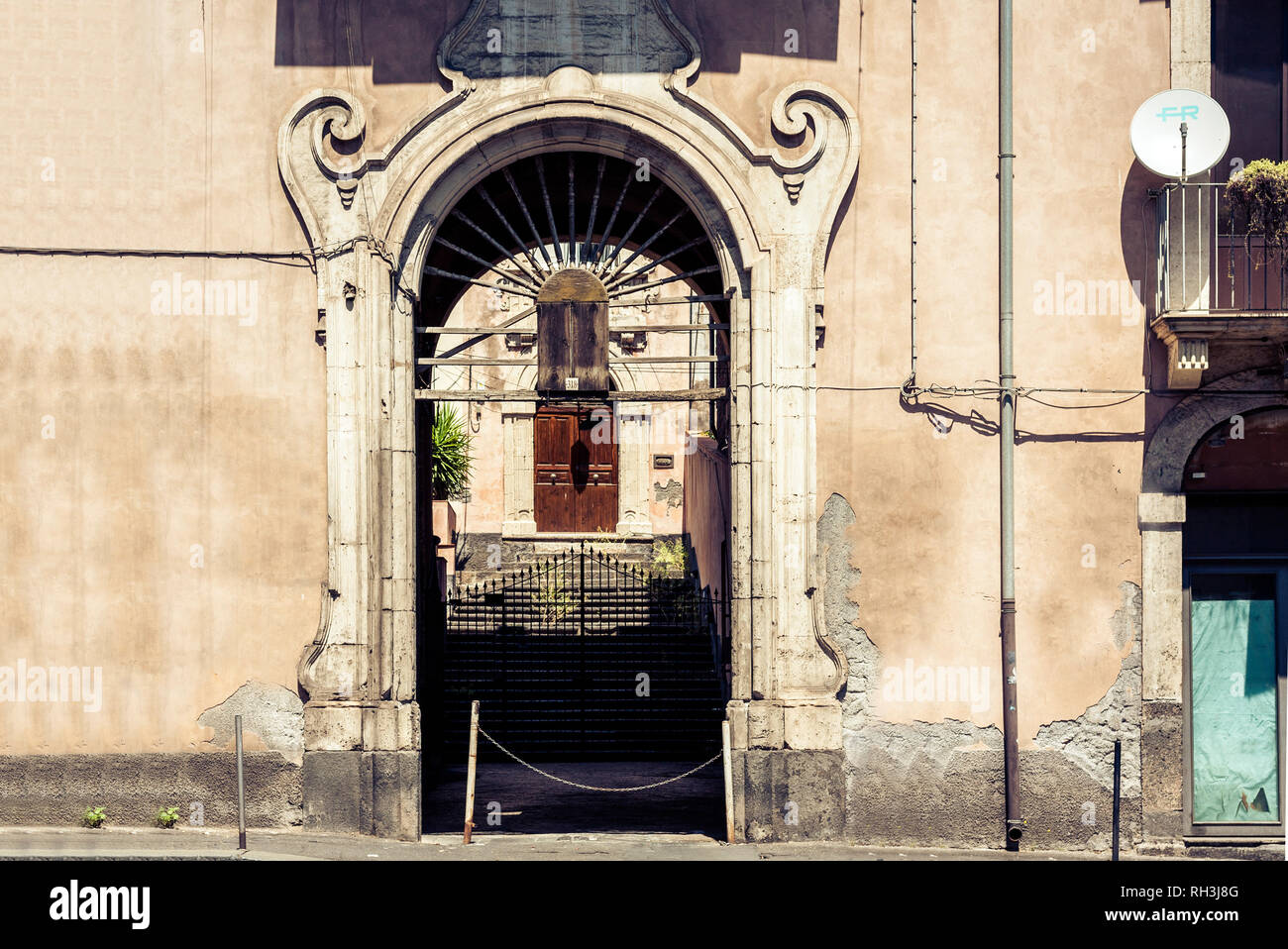Arch, entrance of old houses, historical street of Catania, Sicily ...