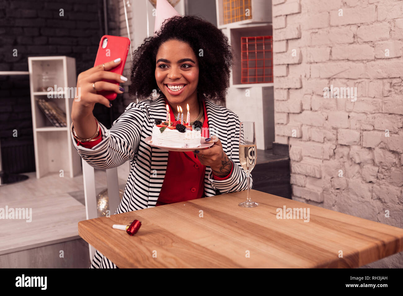 Nice delighted woman taking a picture with the cake Stock Photo - Alamy