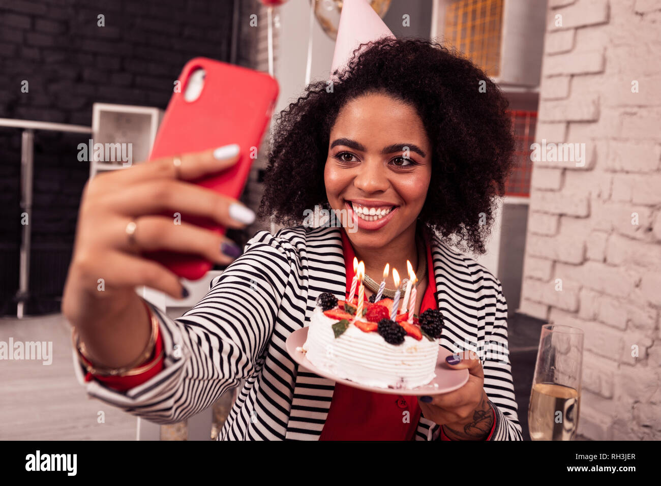 Positive nice woman taking photos on her phone Stock Photo - Alamy
