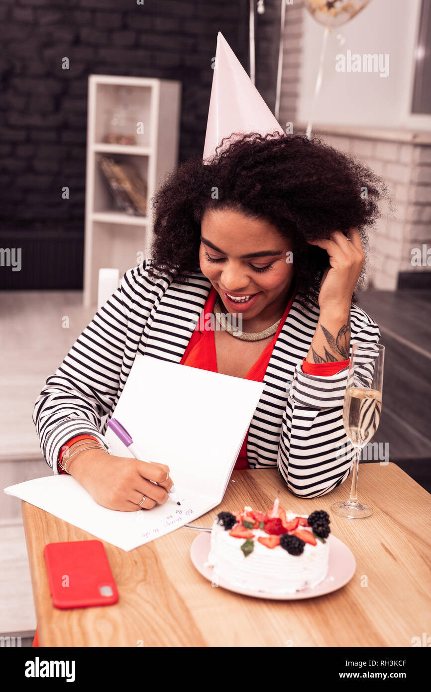 Joyful positive woman creating a plan for her Stock Photo - Alamy