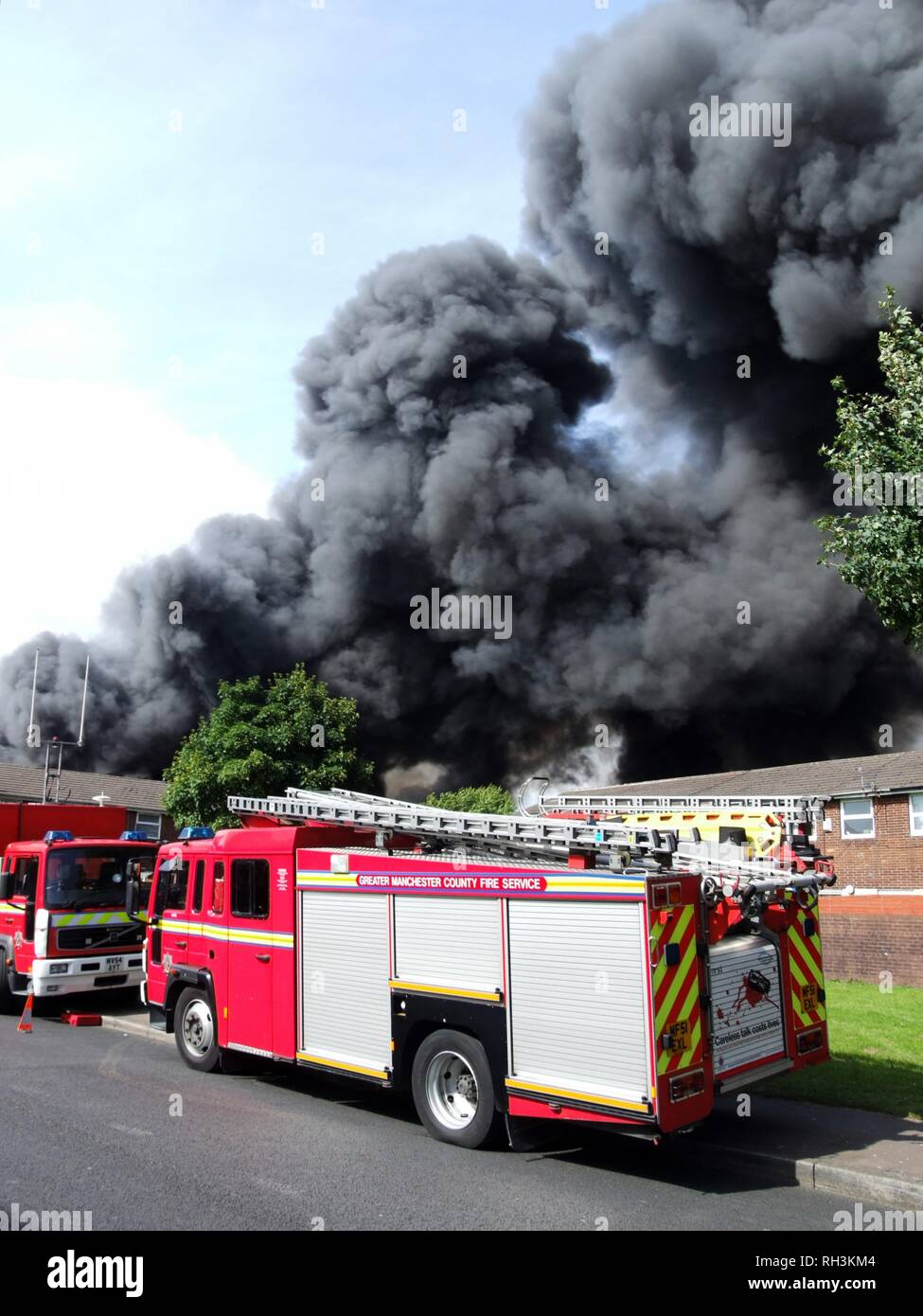 Fire engines on Crossley St with thick column of black smoke visible ...