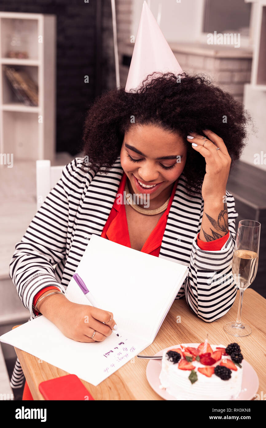 Joyful positive woman thinking what to do Stock Photo - Alamy