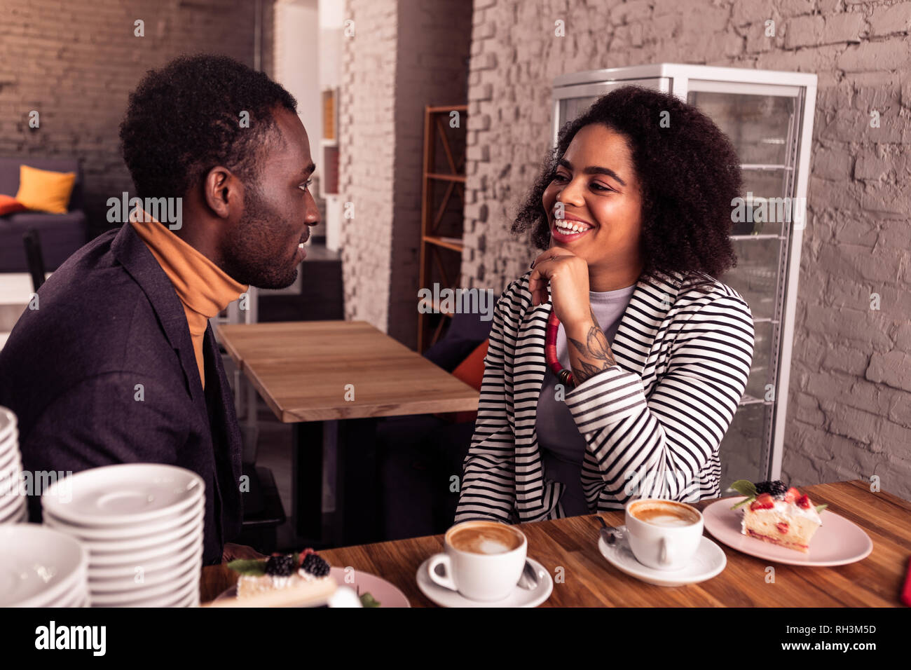 Joyful positive couple talking to each other Stock Photo - Alamy